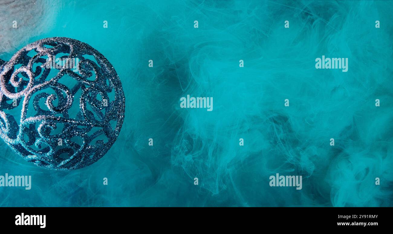 Christmas magic. Cyan smoke background. Shiny intricate Xmas bauble ...