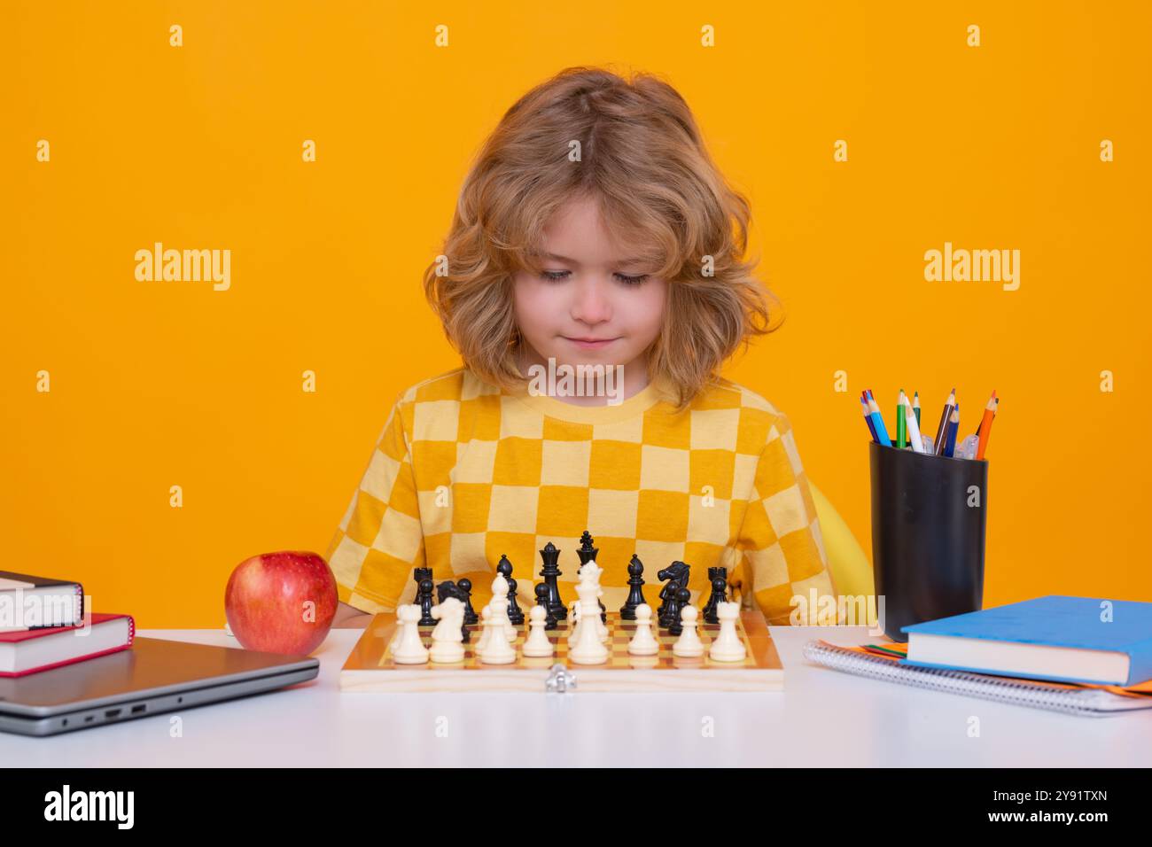 Kid playing chess. Clever child thinking about chess. Kids early development. Kid with chess on ...