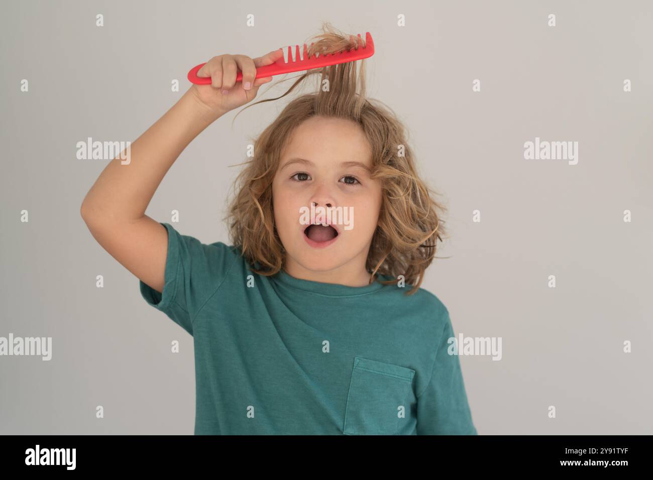 Child combing hair after shower. Kid brushing tangled hair. Funny kids ...