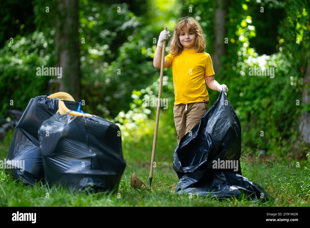 Kid helps to pick up garbage. Pollute forest. Rubbish trash. Planet ...