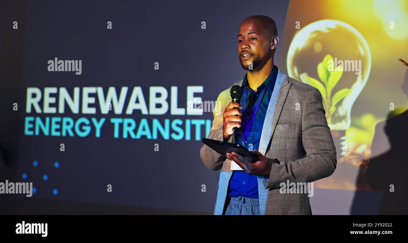 Stage, presenter and black man at seminar with microphone, tablet and ...