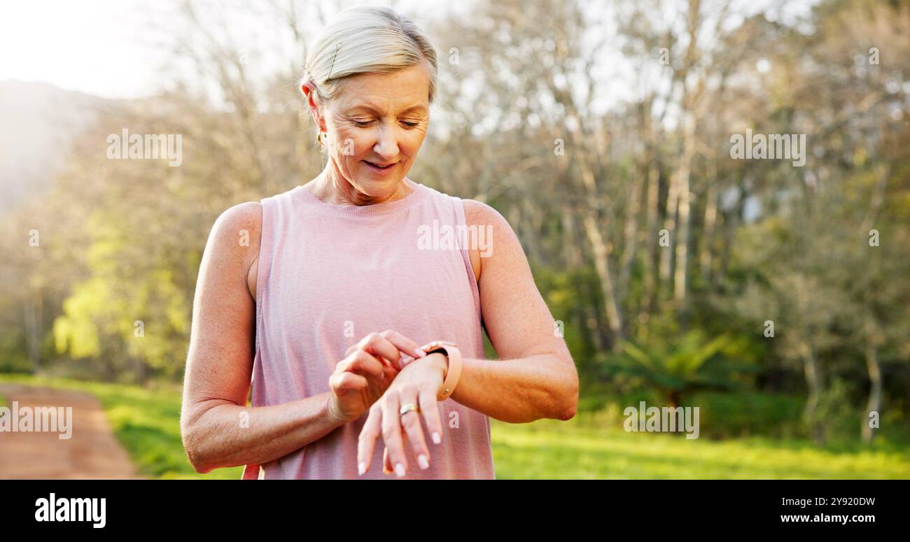 Mature, woman and check smart watch in nature for running performance ...