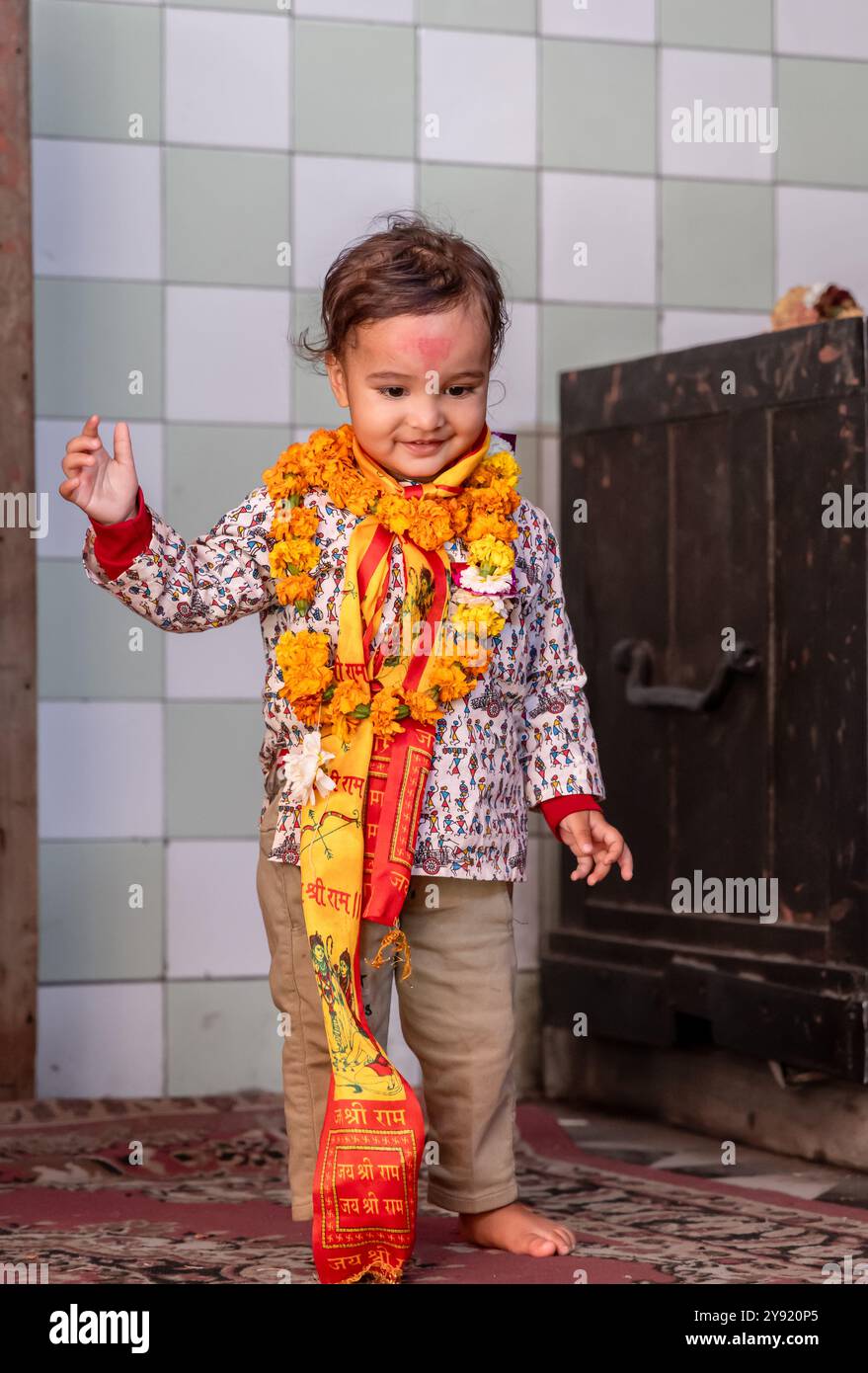 cute kid wearing holy garland at temple from flat angle Stock Photo - Alamy