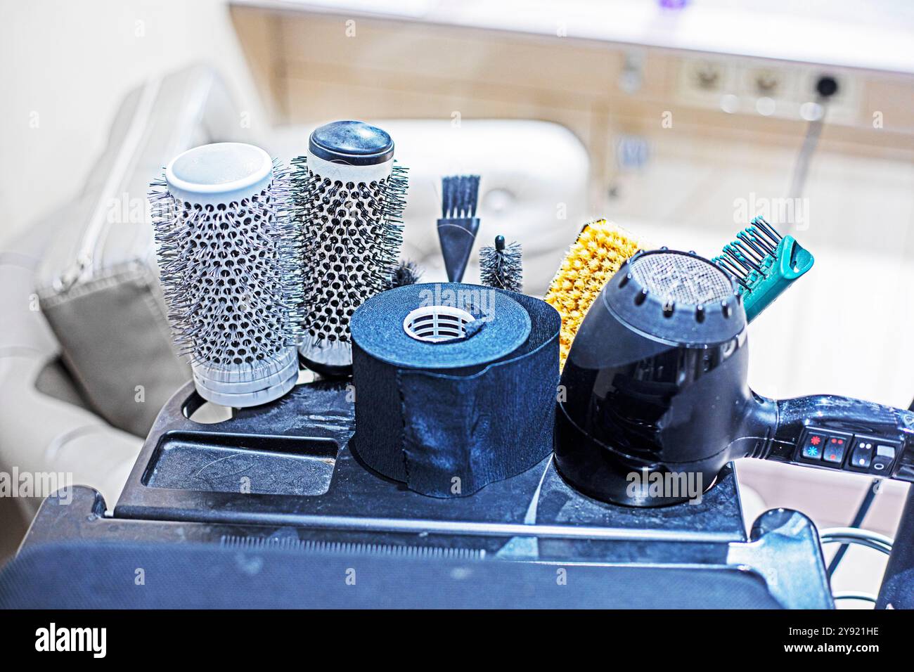 various types of brushes and hair dryers and other hairdressing tools ...