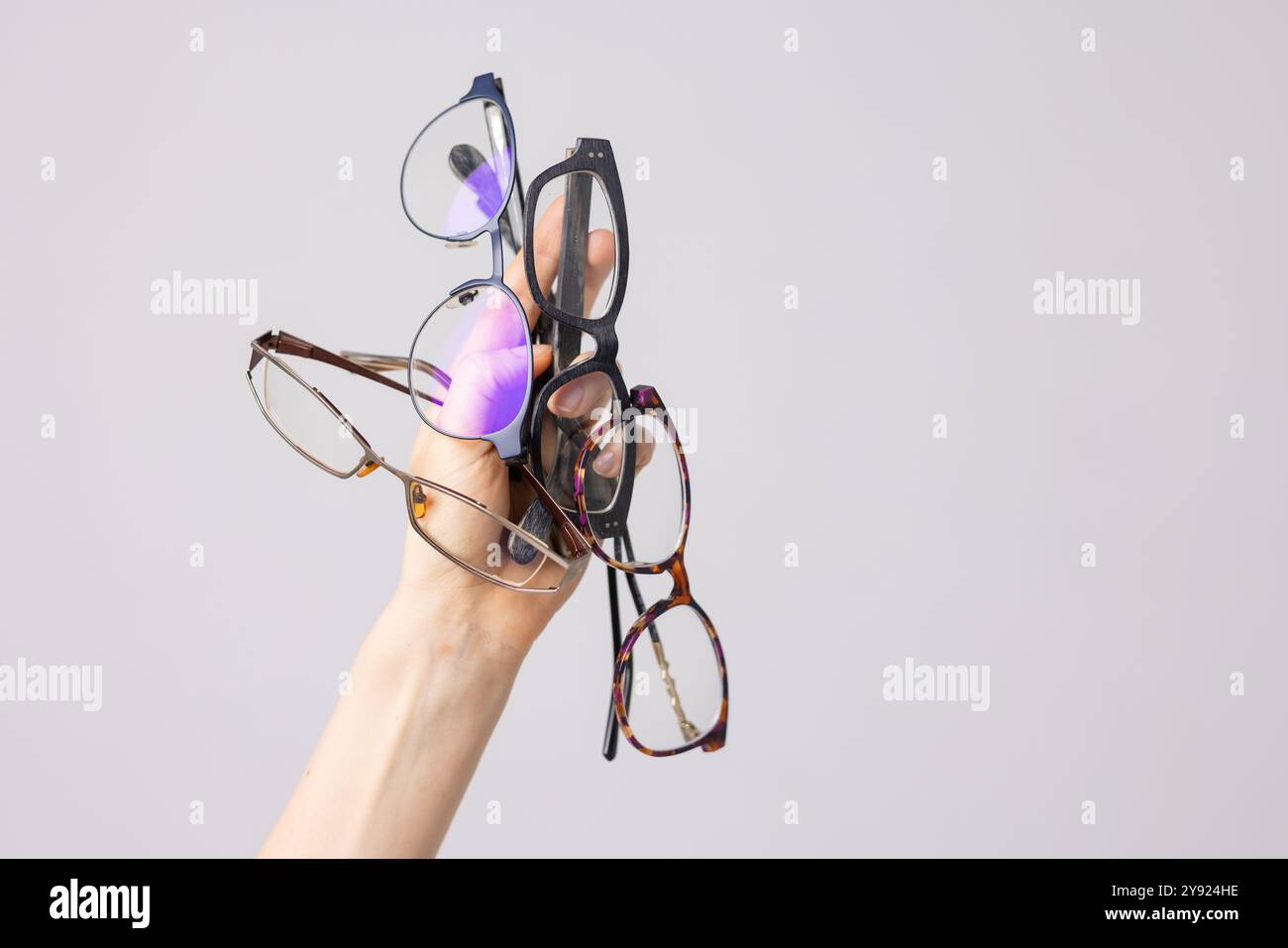 hand holding many glasses for vision on white background, good vision ...