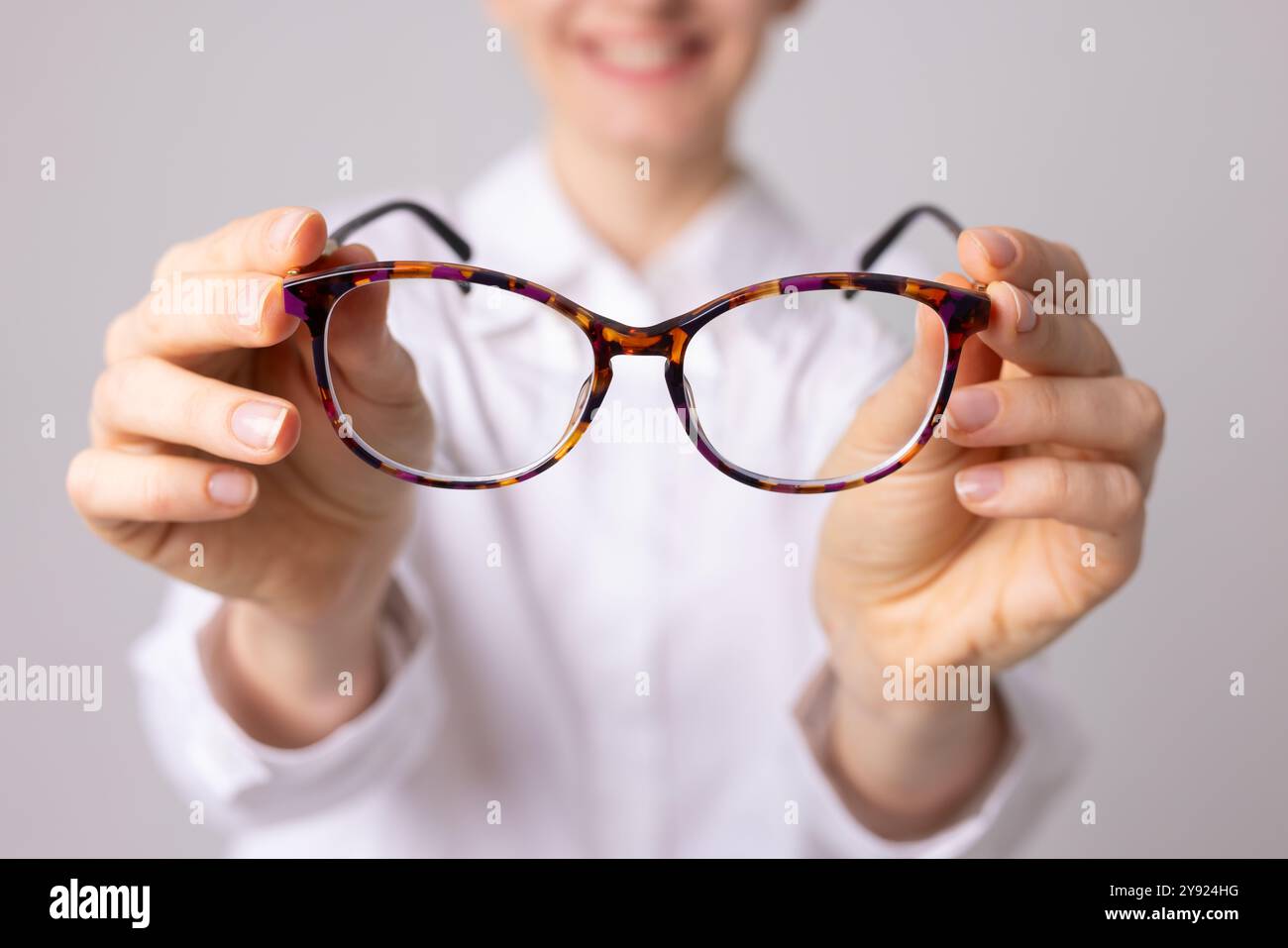Poor vision concept, woman with poor vision holding glasses in front of ...