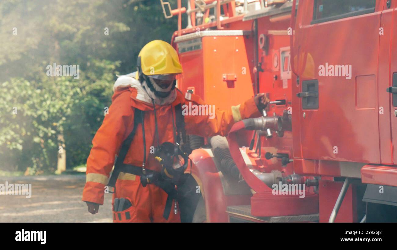 Firefighter fighting with flame using fire hose chemical water foam ...