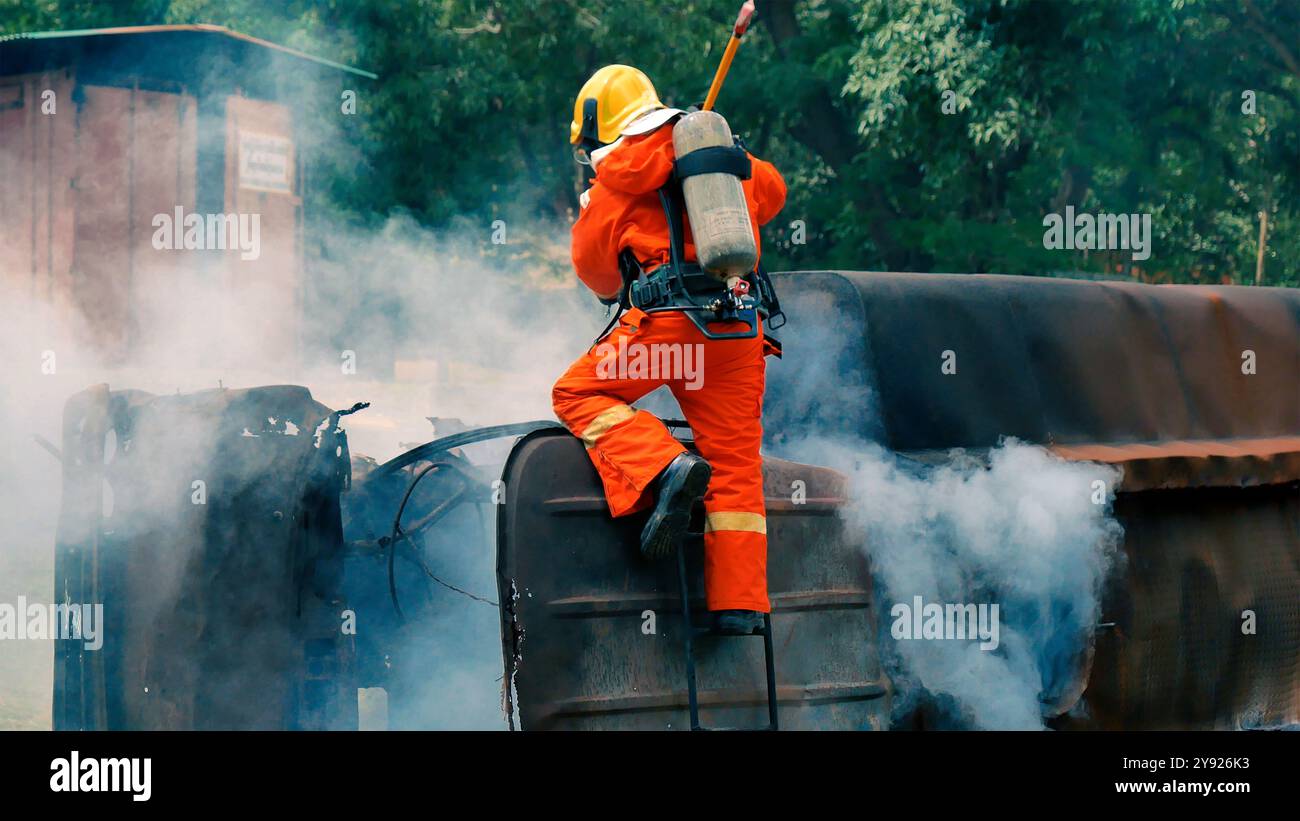 Firefighter fighting with flame using fire hose chemical water foam ...