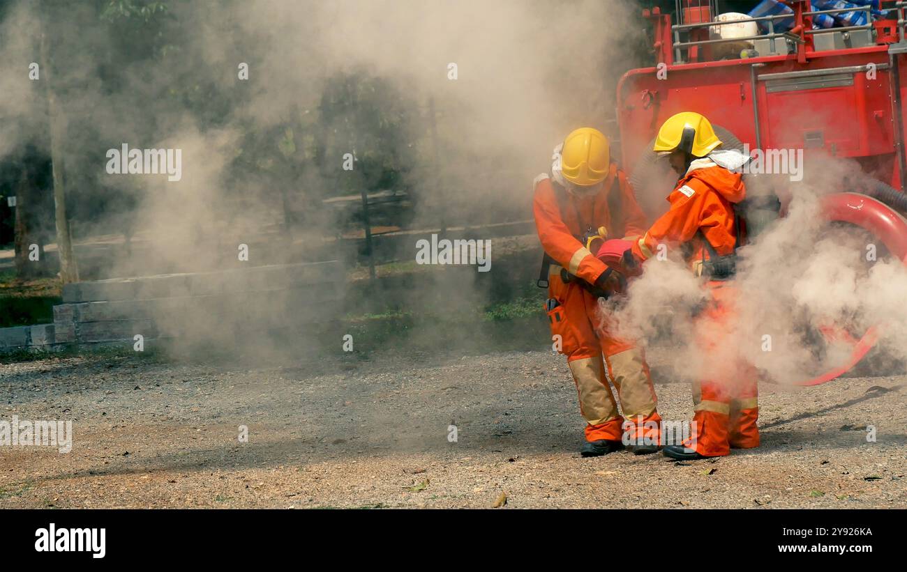 Firefighter fighting with flame using fire hose chemical water foam ...