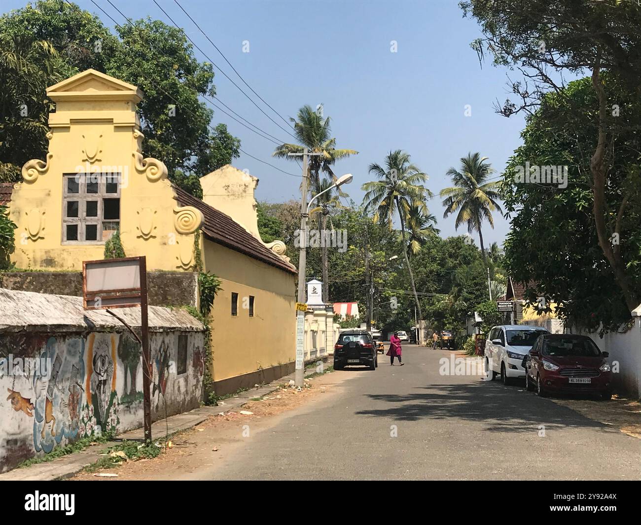 Scenic street view with colonial-style architecture and palm trees ...