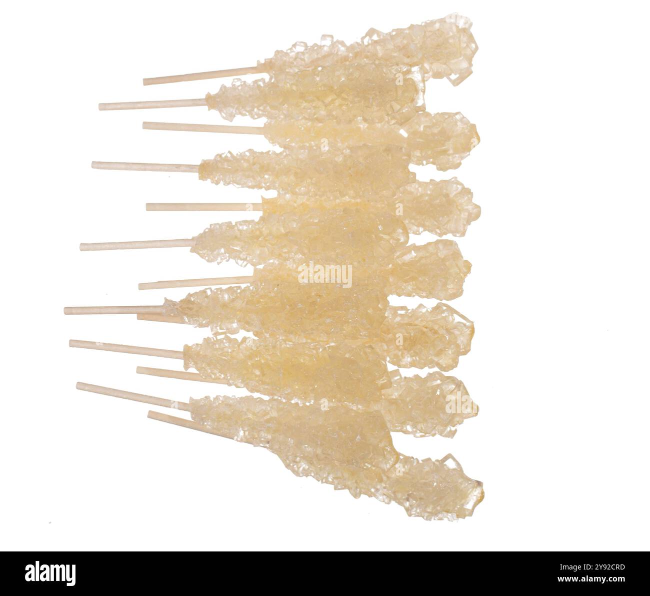 White rock candy sticks on white background, pure crystalized sugar ...