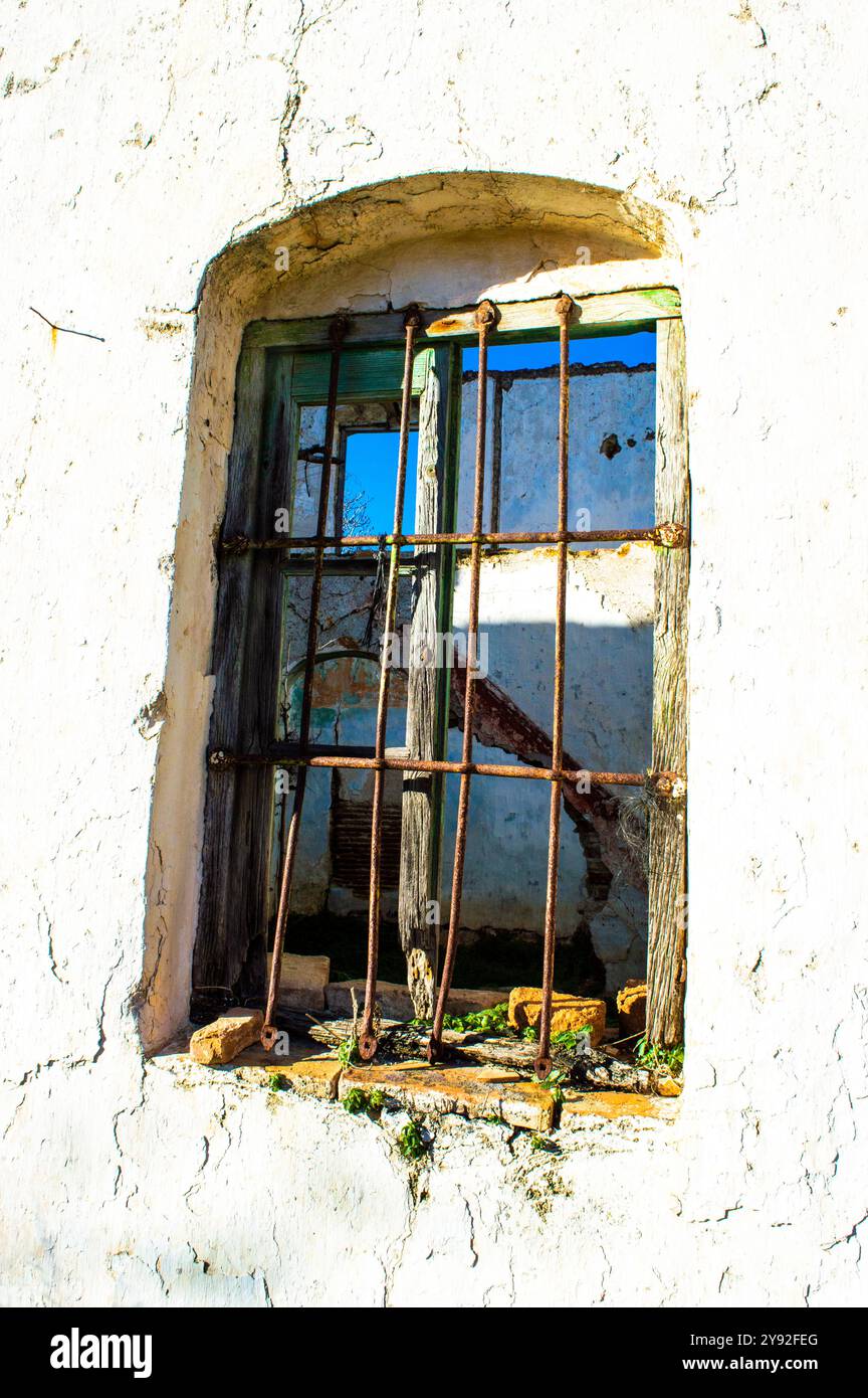 broken and rusty window reveals the interior of an old wheat mill Stock ...