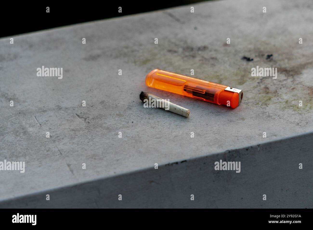 A half-burned weed joint and lighter in a natural, rugged Indian ...