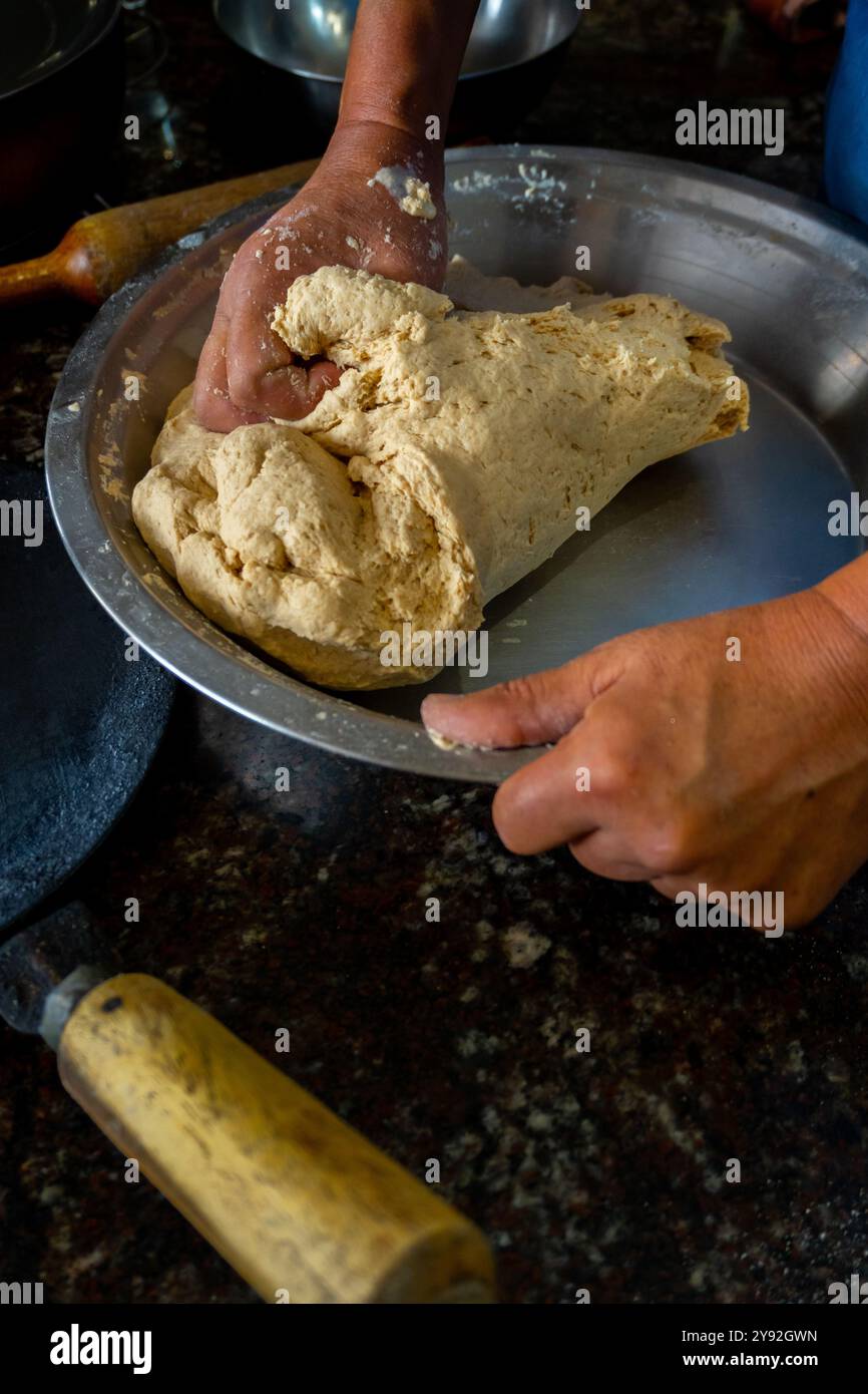 Hands kneading flour for making Indian bread (roti) in a North Indian ...