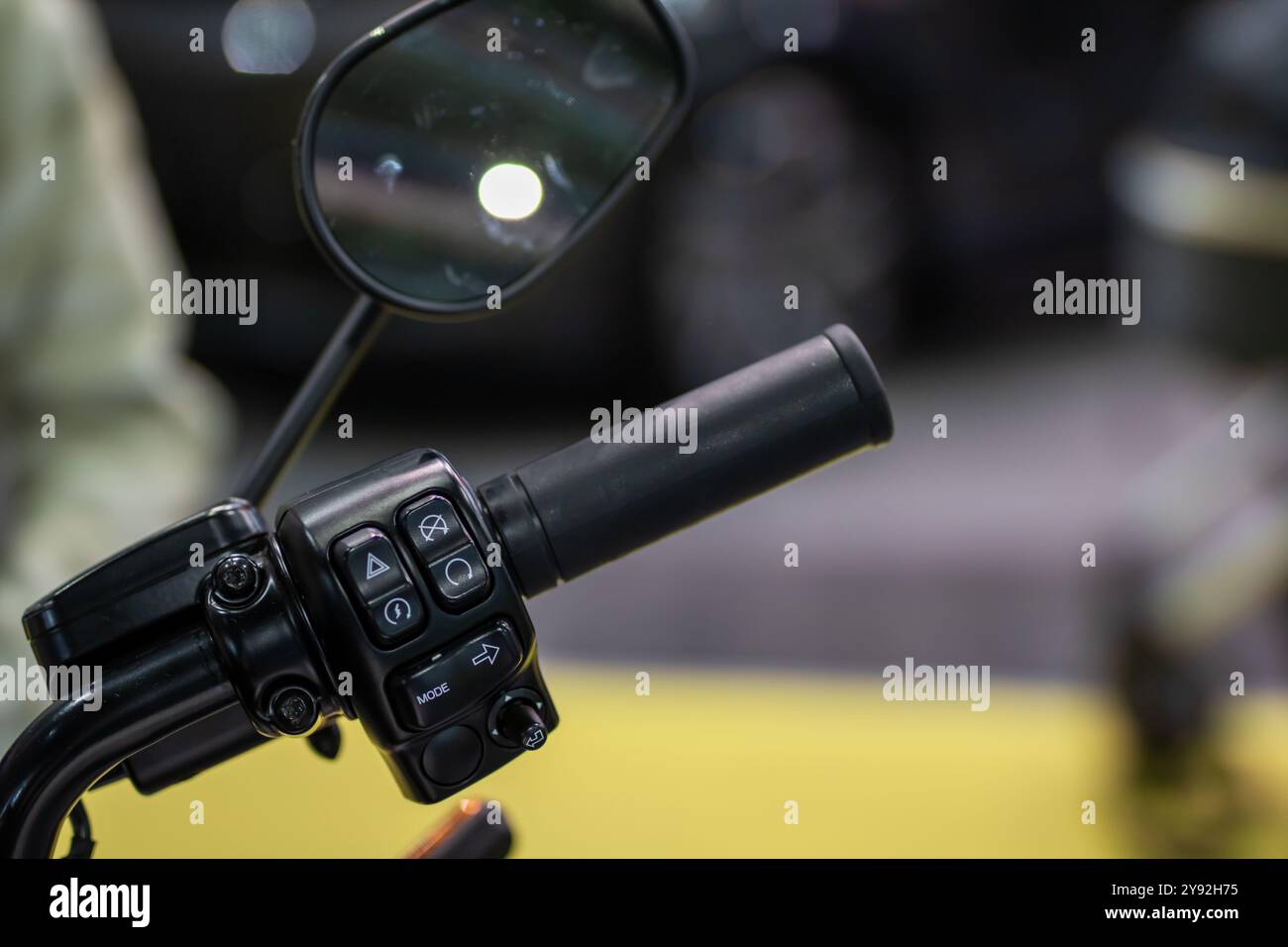 This image features a detailed closeup of a motorcycle handlebar ...