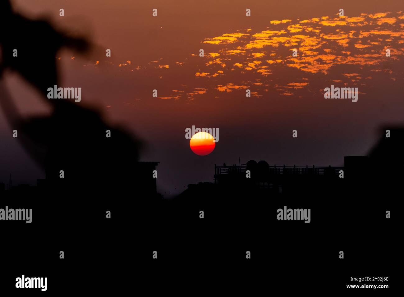 A mesmerizing golden hour sunset with a burning orange sun and ...