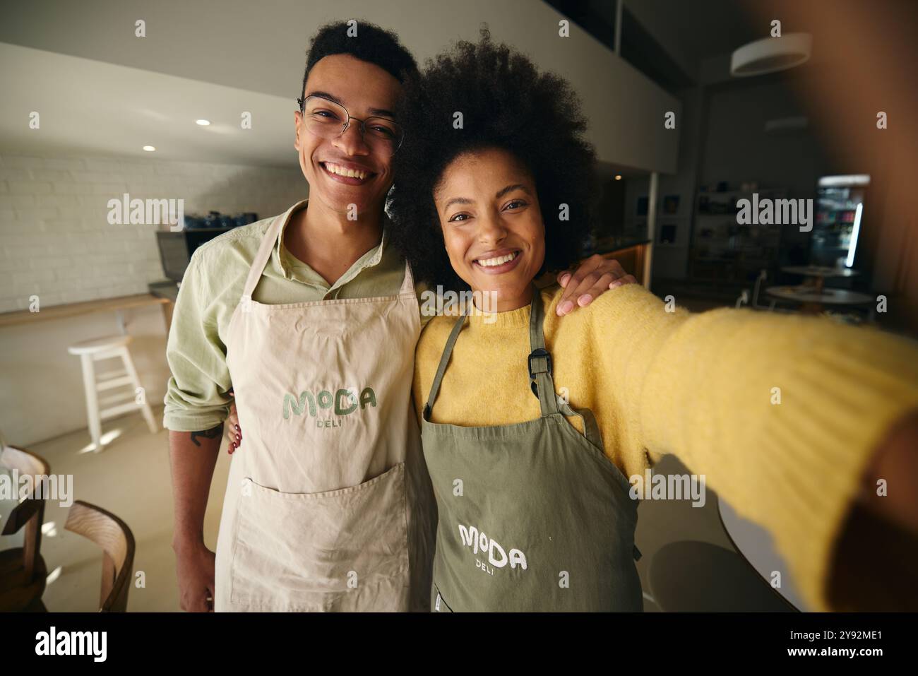A waiter and waitress taking a photo together at work Stock Photo - Alamy