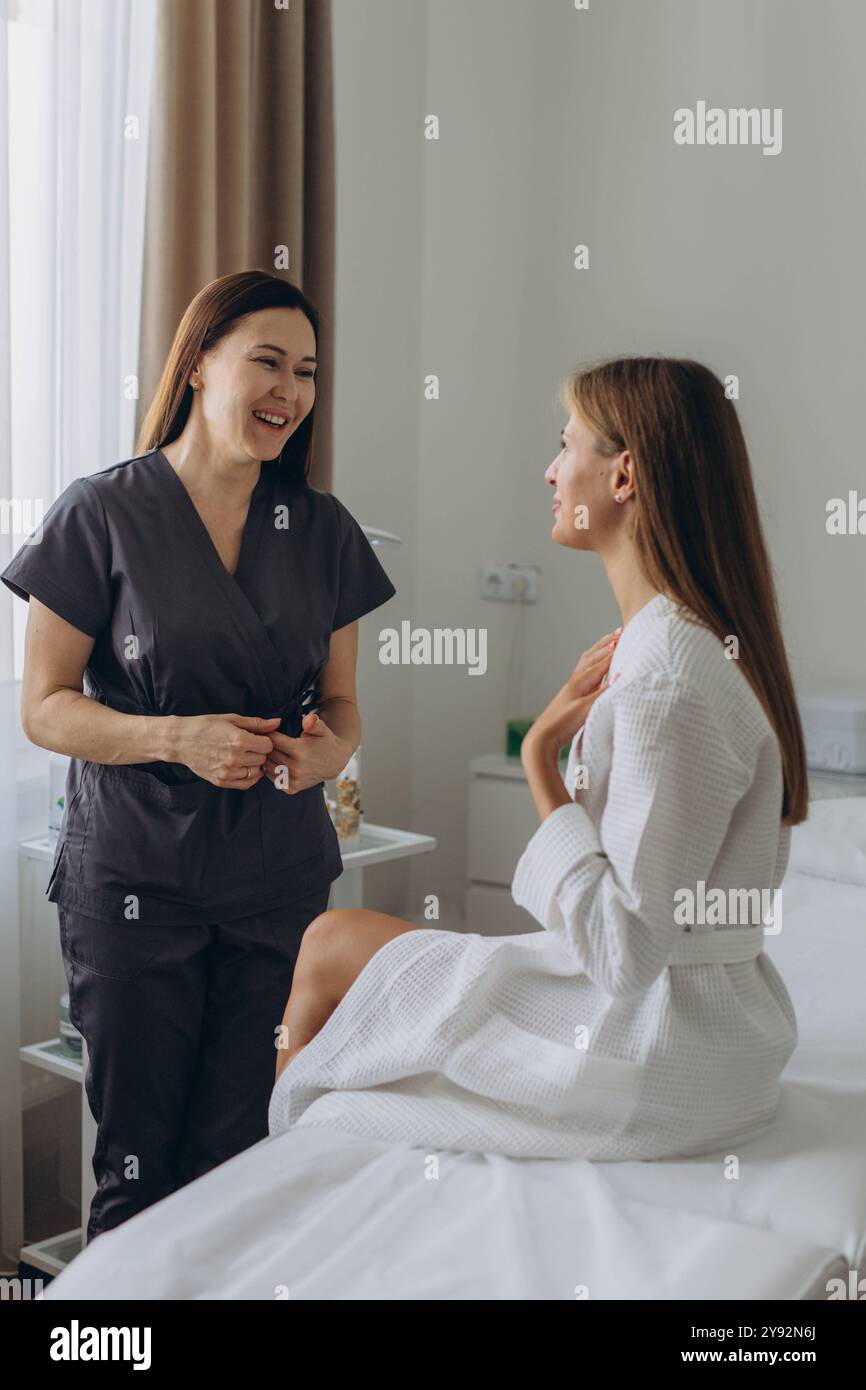 Consultation in cosmetology clinic. Female beauty doctor talking with ...