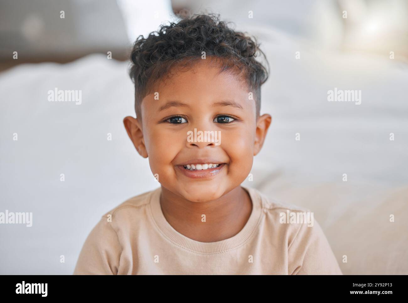 Boy, portrait and smile in home with happy, growth and development in ...