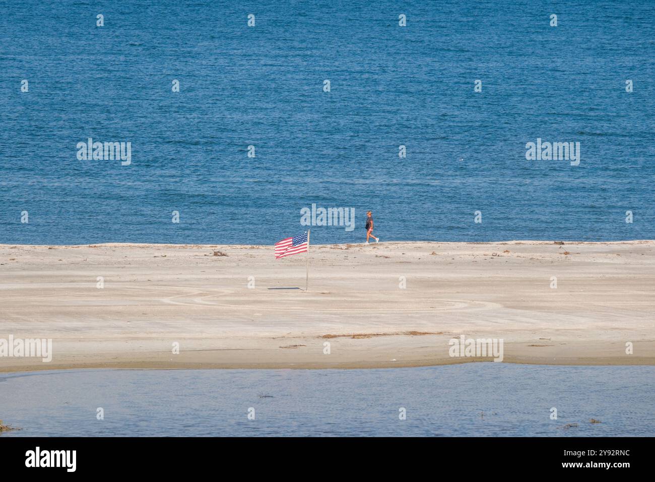 Clearwater, FL, USA - 02 Oct 2024 - A strip of beach behind a lagoon on ...