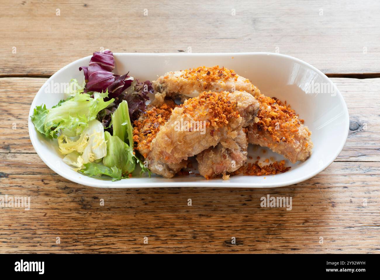 Salt and chilli seasoned chicken wings starter or side plate Stock ...