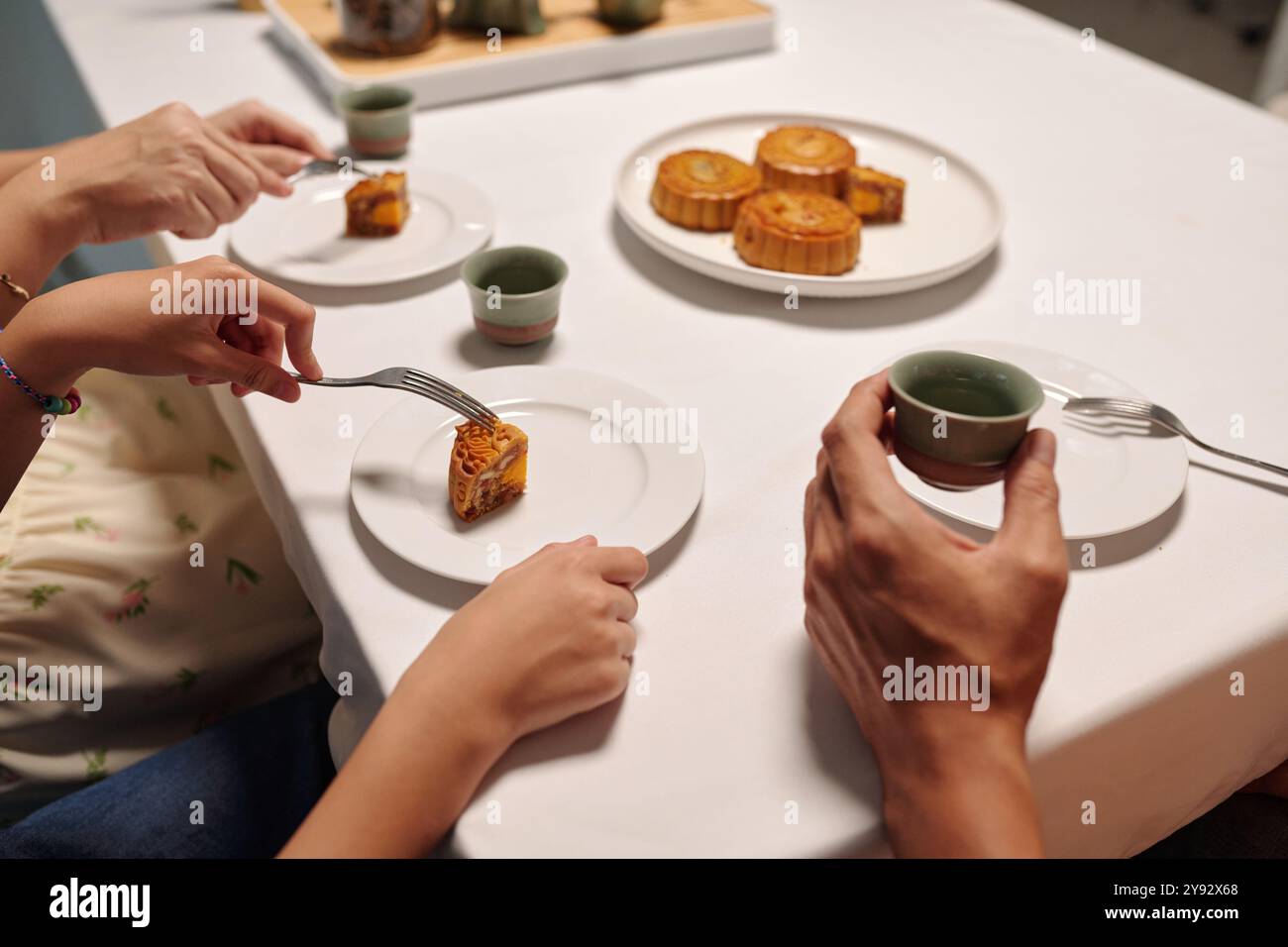 Family Eating Moon Cakes At Dining Room Stock Photo - Alamy