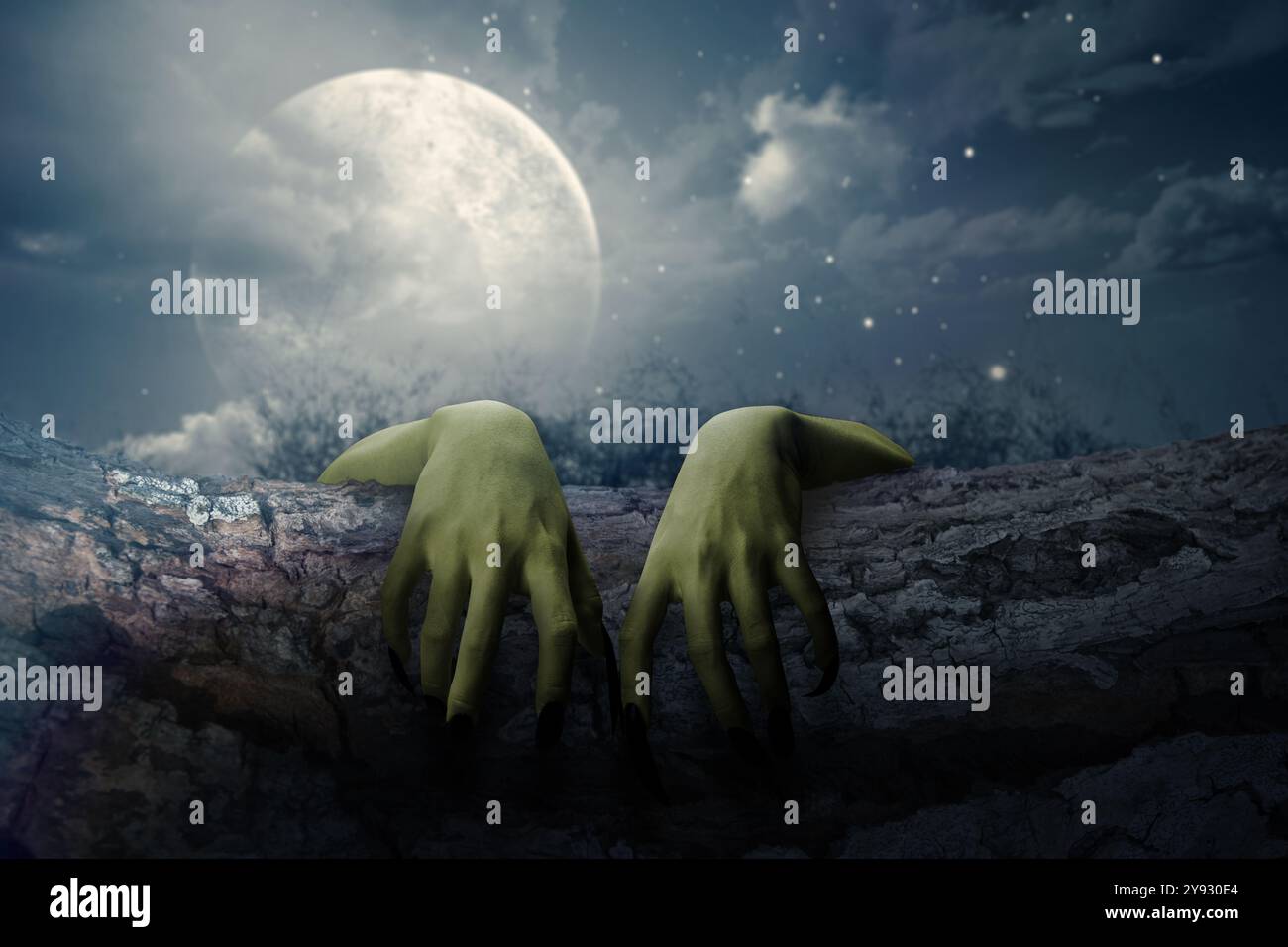 Two witch hands reaching out from a wooden log with full moon ...