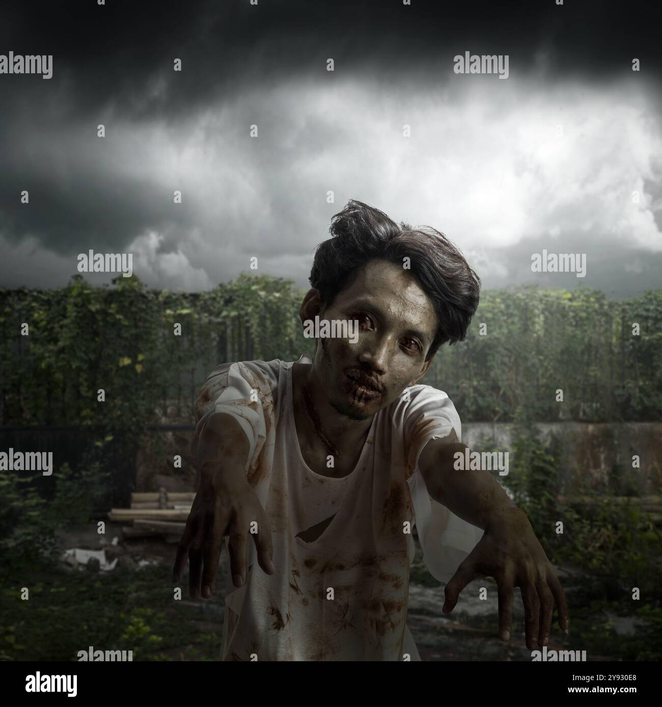 Zombie with bloody wound standing with moonlight background. Scene is ...