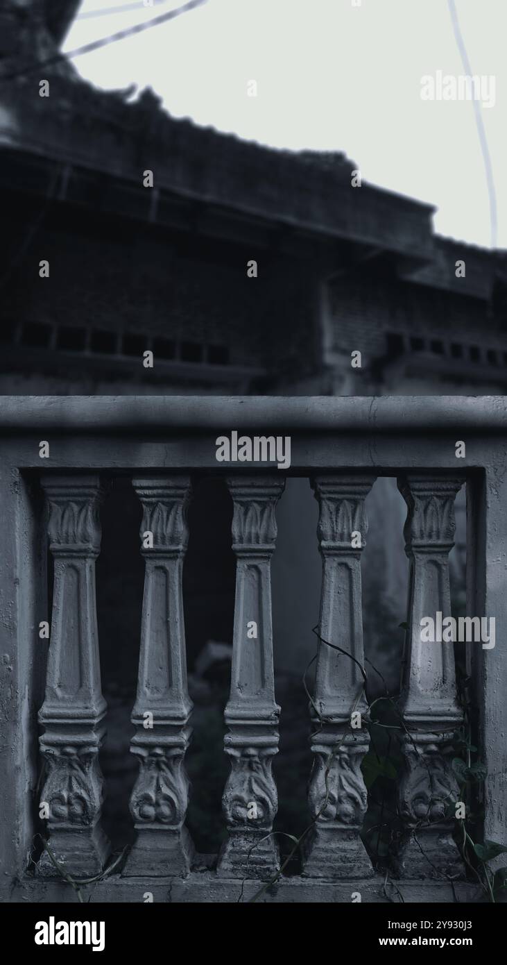 Black balustrade with five pillars and abandoned building background ...