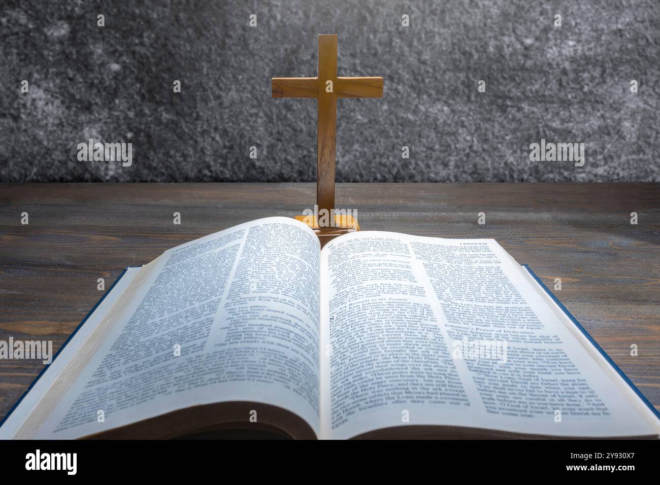 Wooden religion cross and opened blue book of Holy Bible. Christian ...