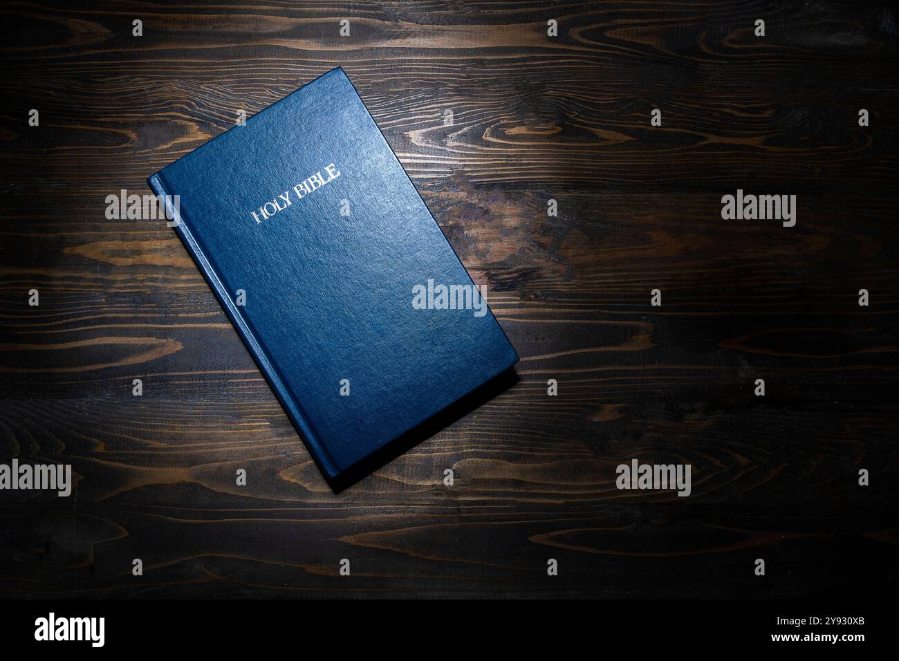 Blue book with the word Holy Bible on the front. Christian background ...
