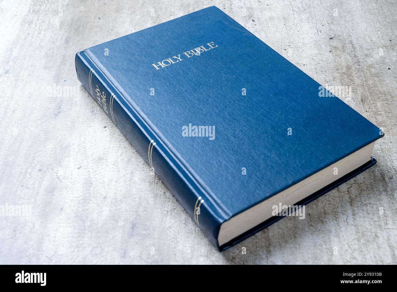 Blue book with the word Holy Bible on the front. Christian background ...