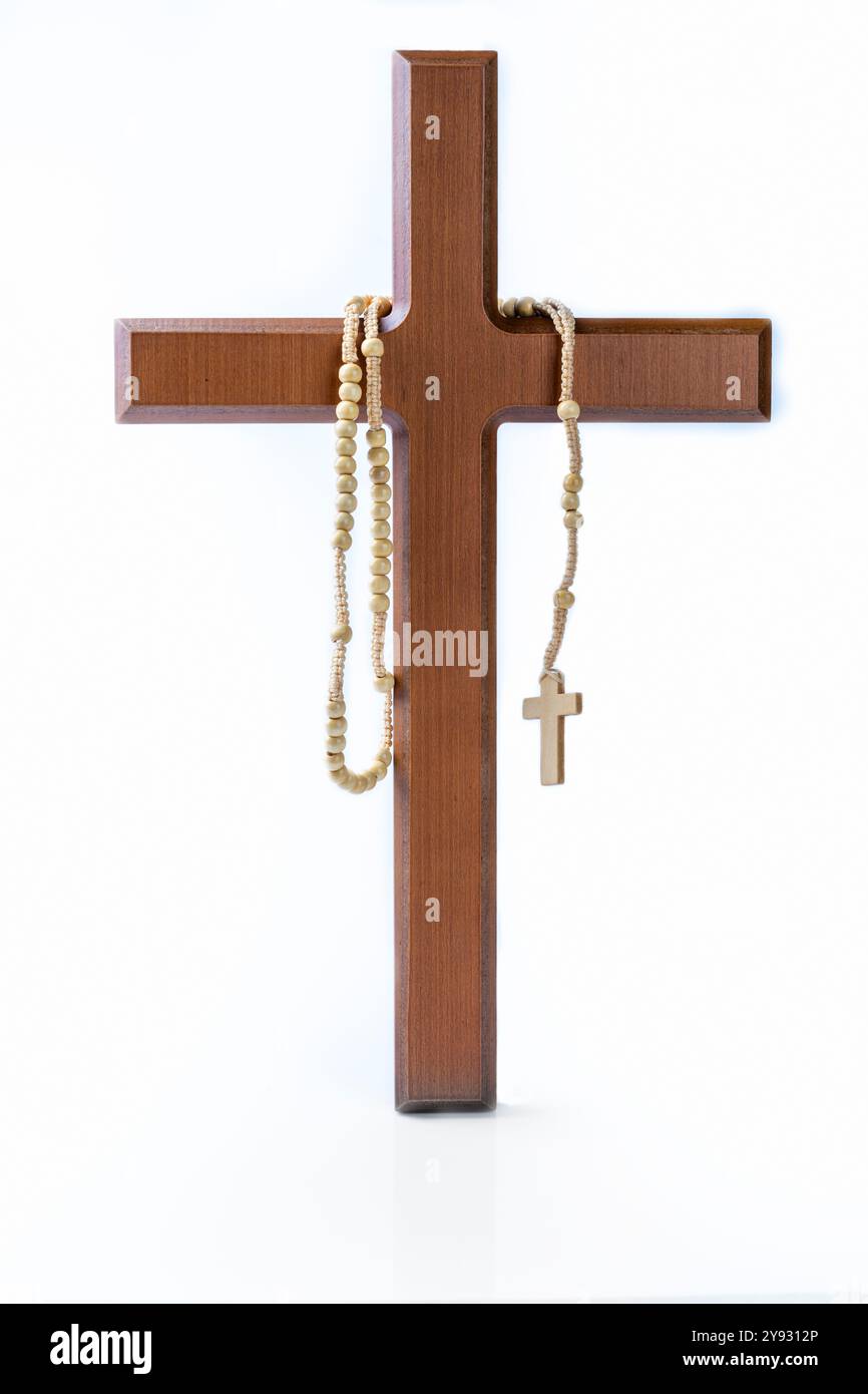 Wooden religion cross and rosary beads isolated over white background ...