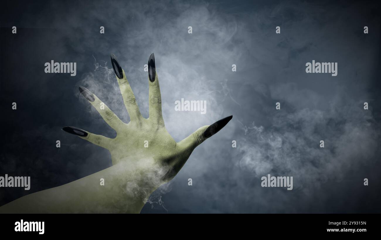 Witches hand with long nail claw is reaching out. The color is green ...