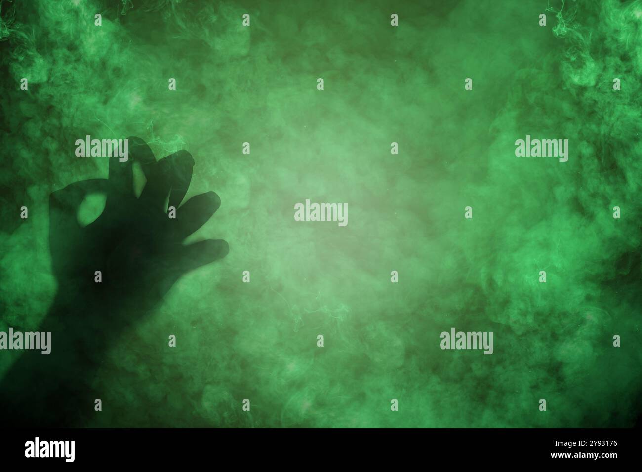 Shade of witch hands on dark background. The hand appearing to be devil ...