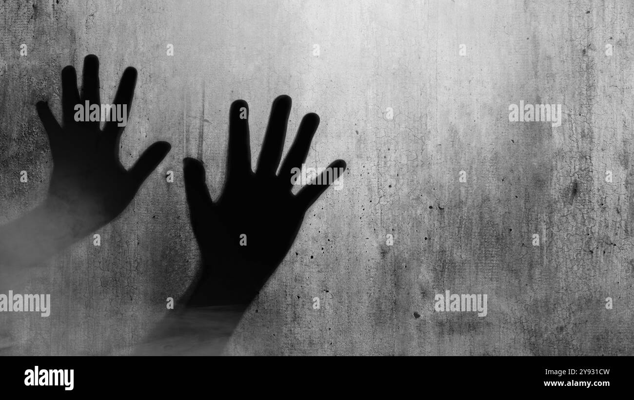 Shade of zombie hands on dark background. The hand appearing to be ...