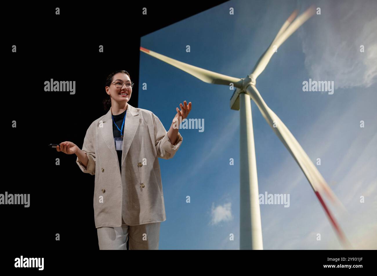 A woman is talking about renewable energy on stage Stock Photo - Alamy