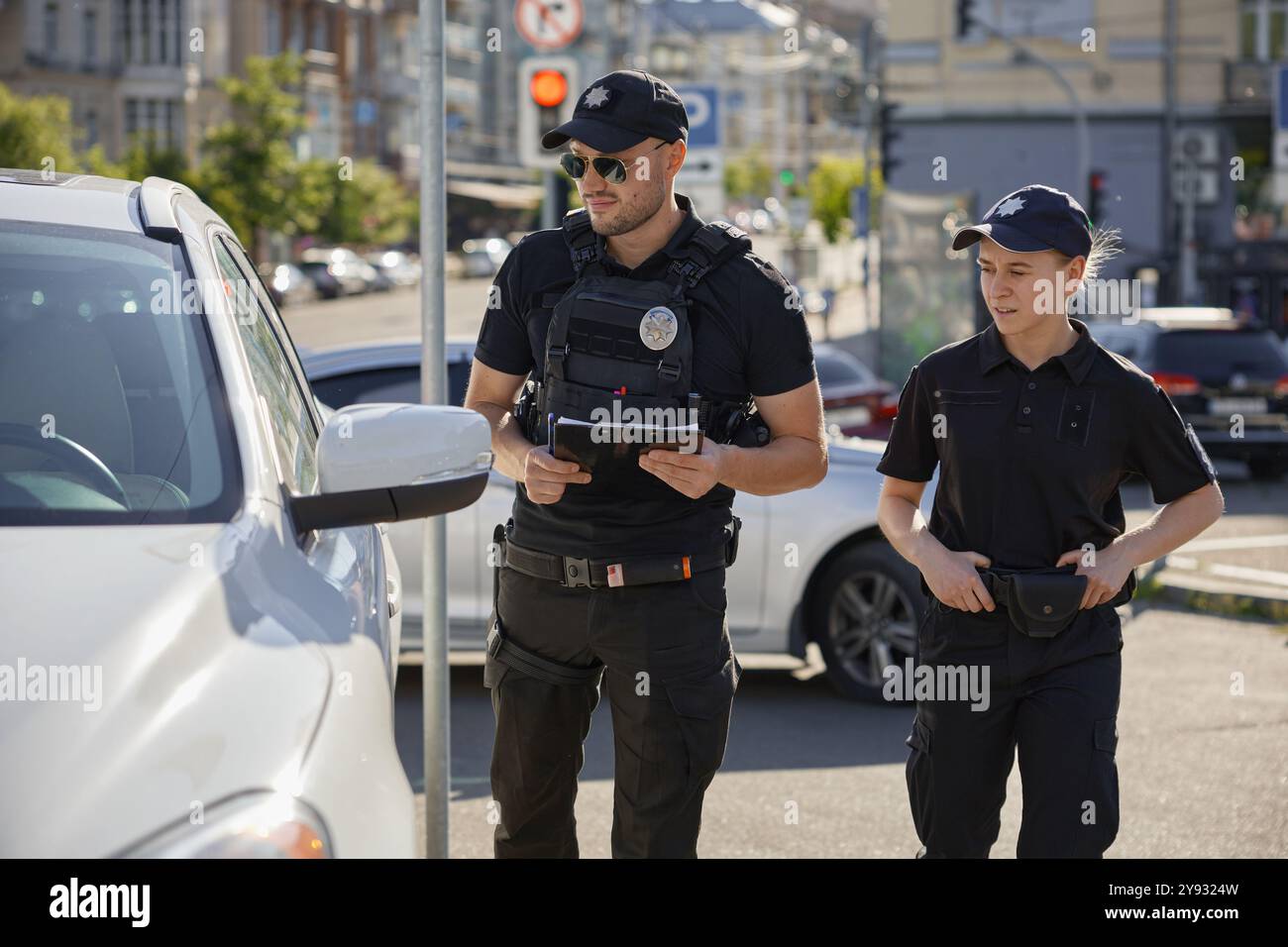 Woman and man patrol police team working on street Stock Photo - Alamy
