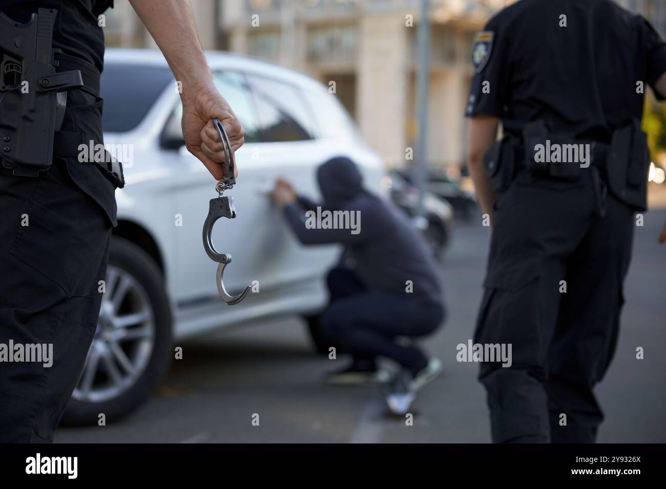 Police team catching and arresting car burglar, closeup view on ...
