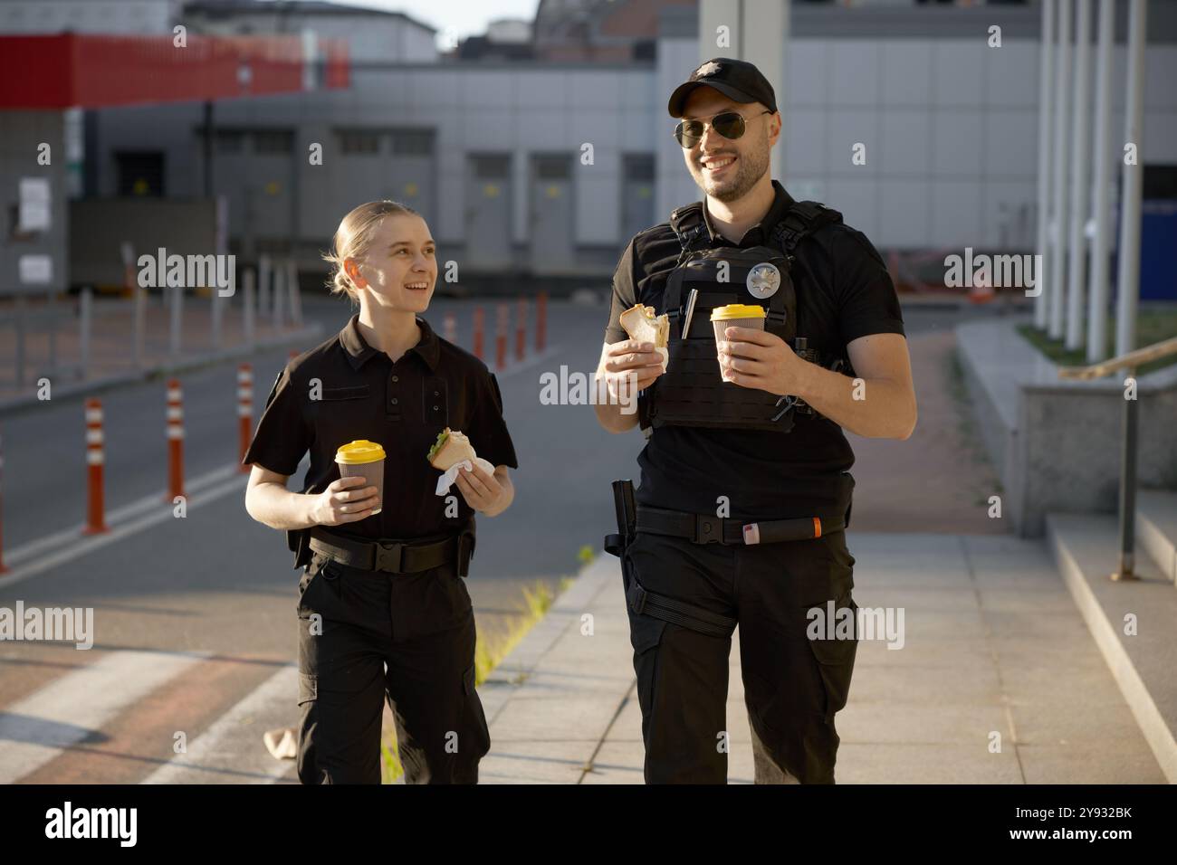 Happy smiling male and female patrol police officers enjoying lunch ...