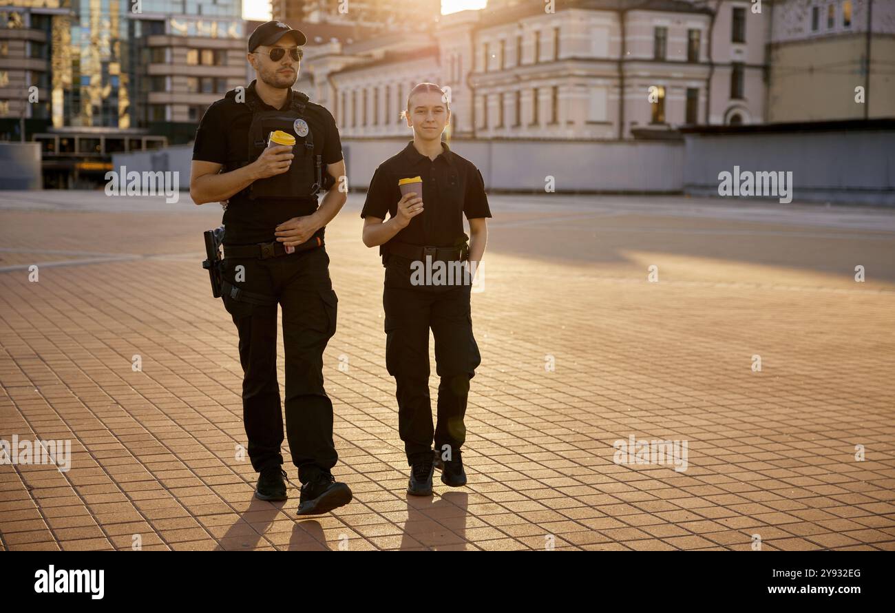 Happy smiling male and female patrol police officers enjoying lunch ...