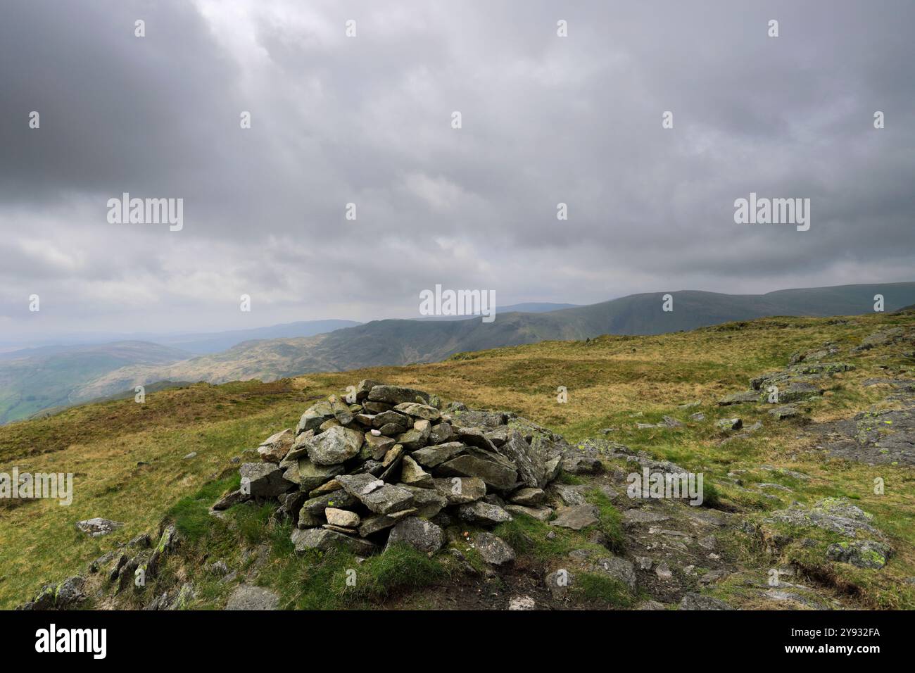 The summit cairn of Grey Crag fell, above the hamlet of Sadgill ...