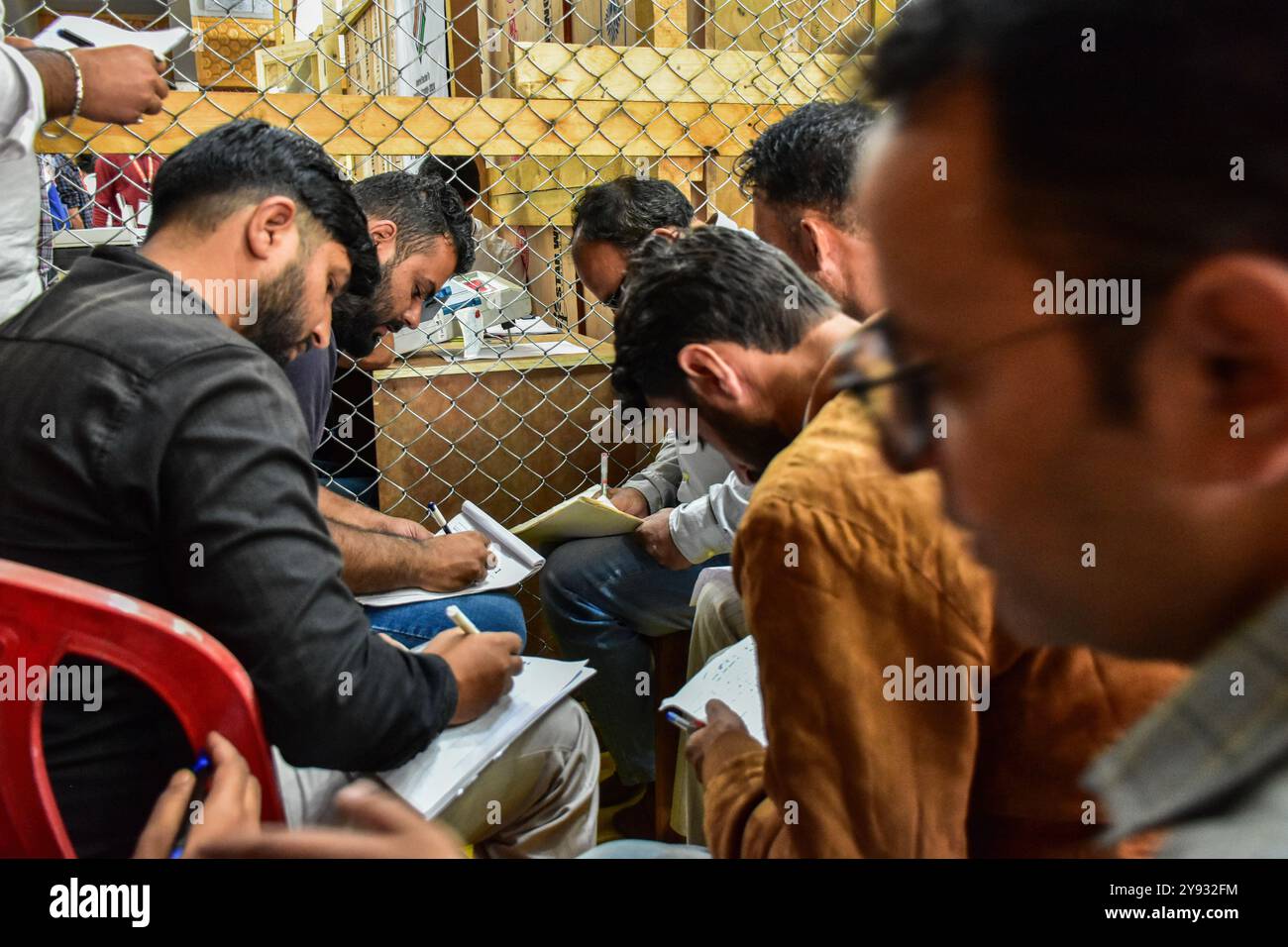 Electoral officials tally votes from an Electronic Voting Machine (EVM ...