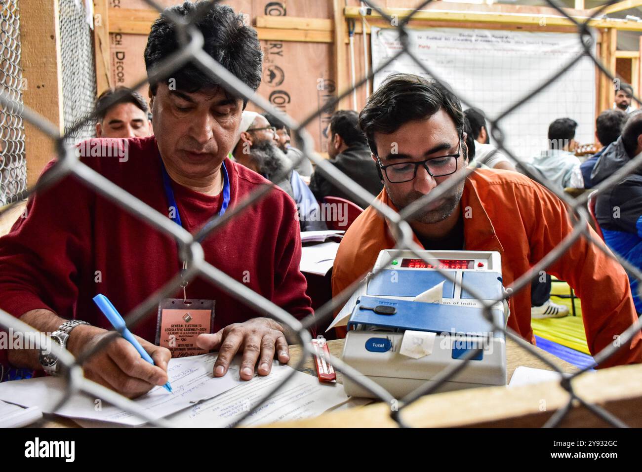 Electoral officials tally votes from an Electronic Voting Machine (EVM ...