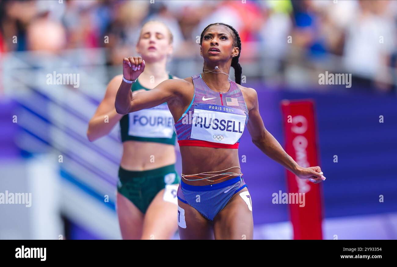 Masai Russell participating in the 100 meters hurdles at the Paris 2024 ...