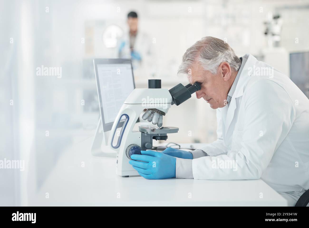 Mature man, science lab and medical research with microscope as ...