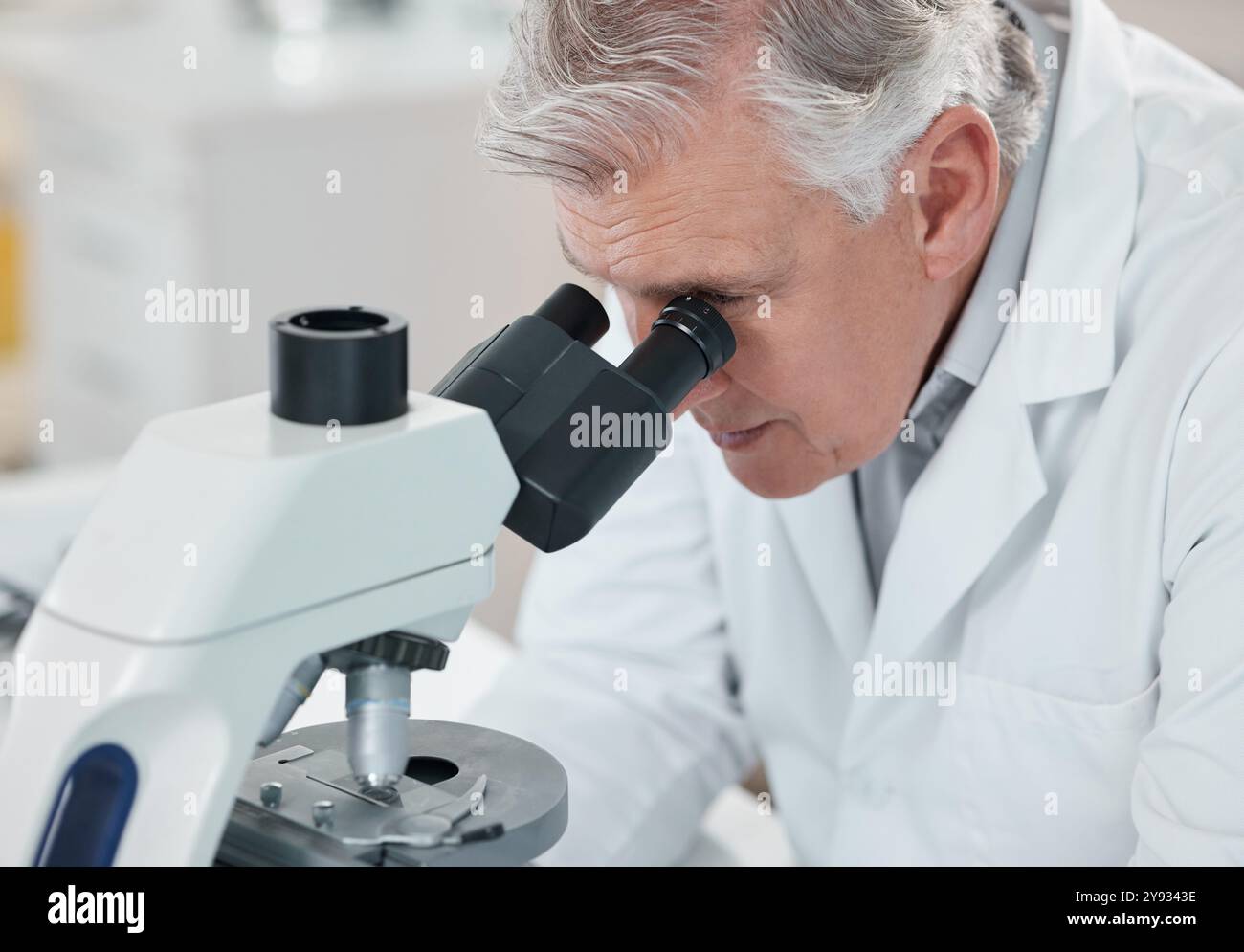 Mature man, scientist and medical research with microscope in science ...