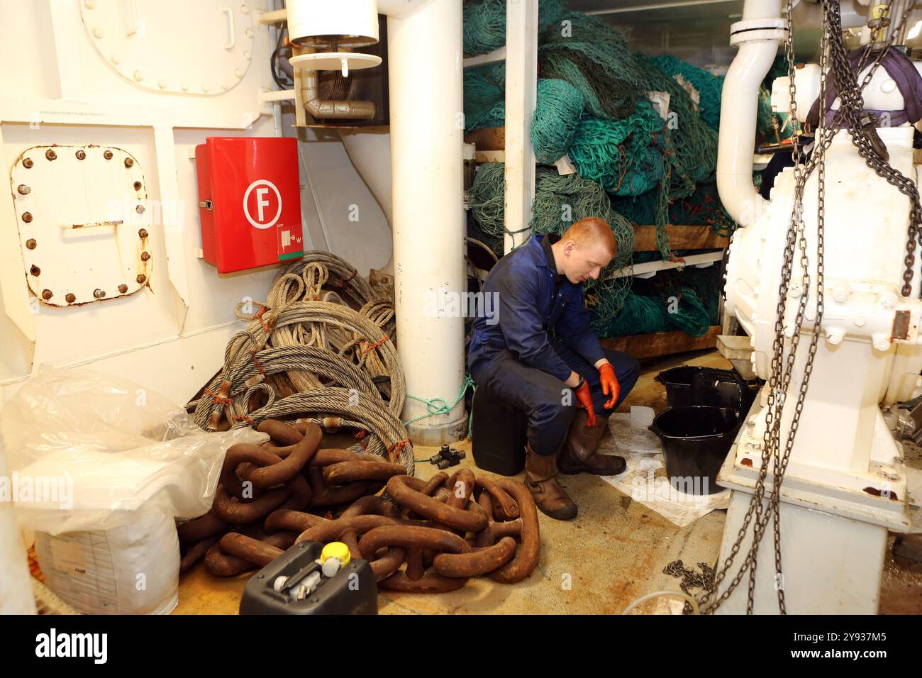 A Deckhand draining pipes onboard the Kirkella. The Kirkella is a ...