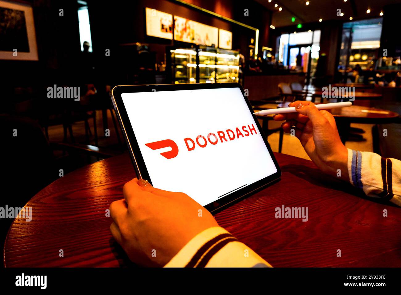 In this photo illustration, a DoorDash logo is displayed on the screen ...