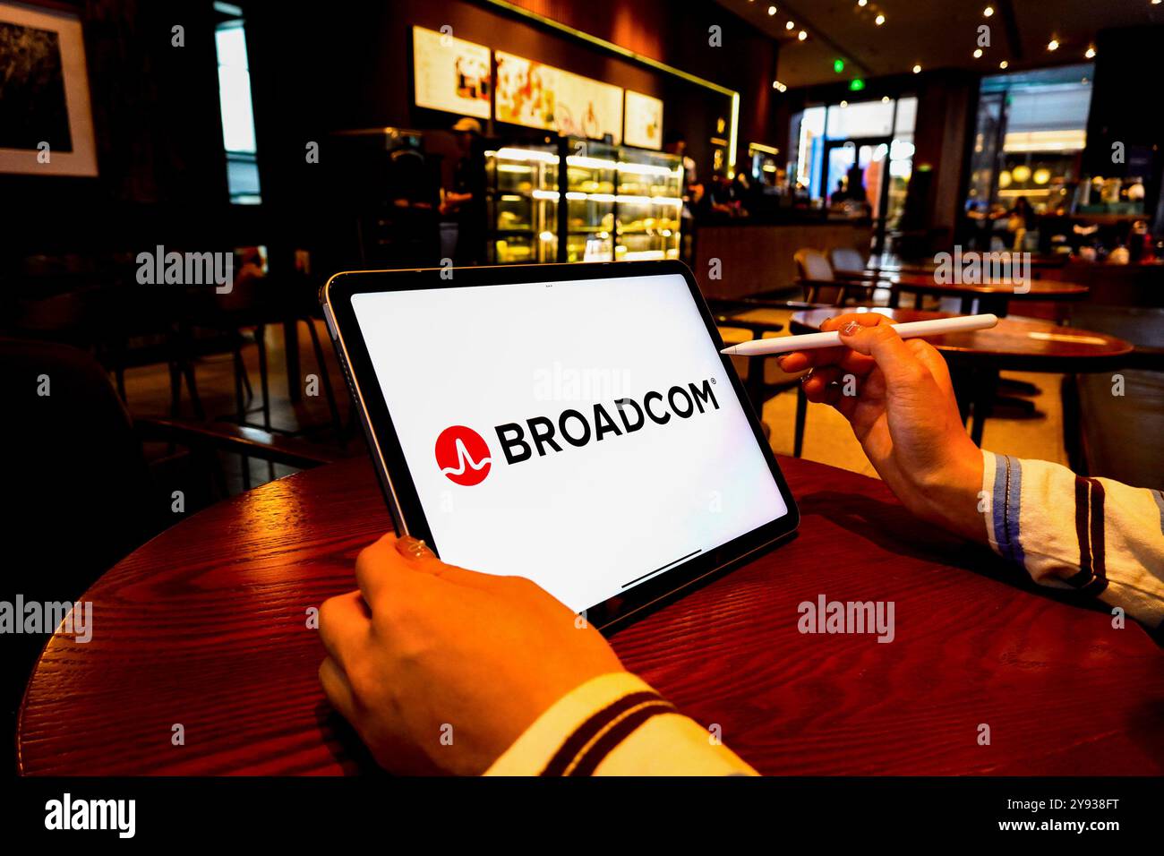 In this photo illustration, a Broadcom logo is displayed on the screen ...